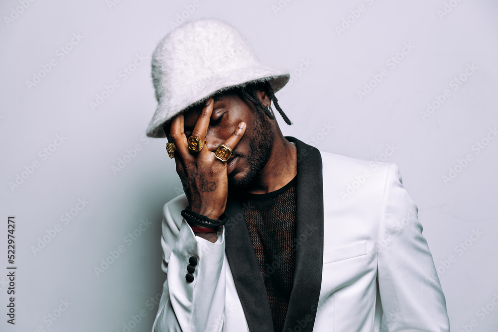 artistic portrait with gel lights. Handsome man posing on colored ...