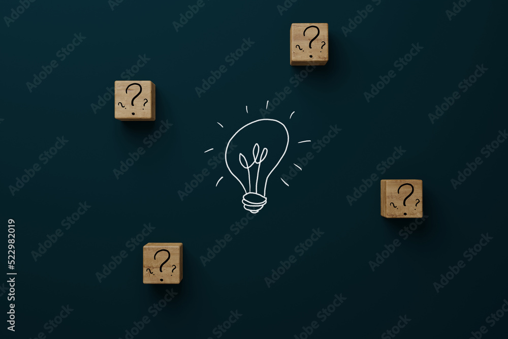 Wooden blocks with a question mark icon and a drawn light bulb. Concept ...