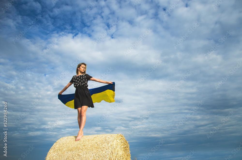 Independence Day of Ukraine. The girl is wrapped in the Ukrainian flag ...