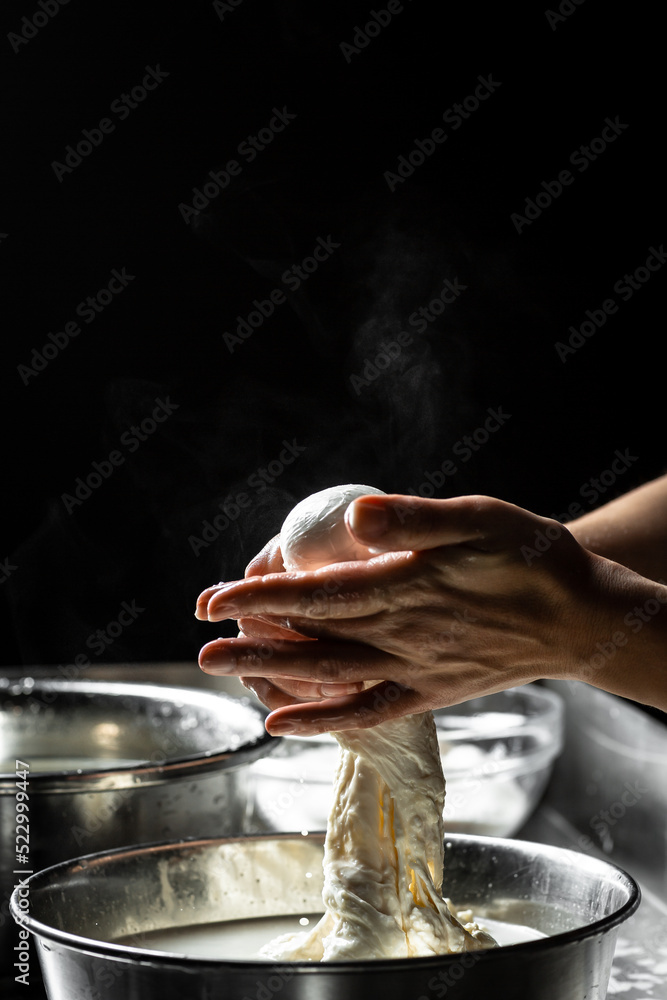 Production process of mozzarella cheese. woman working in a small ...