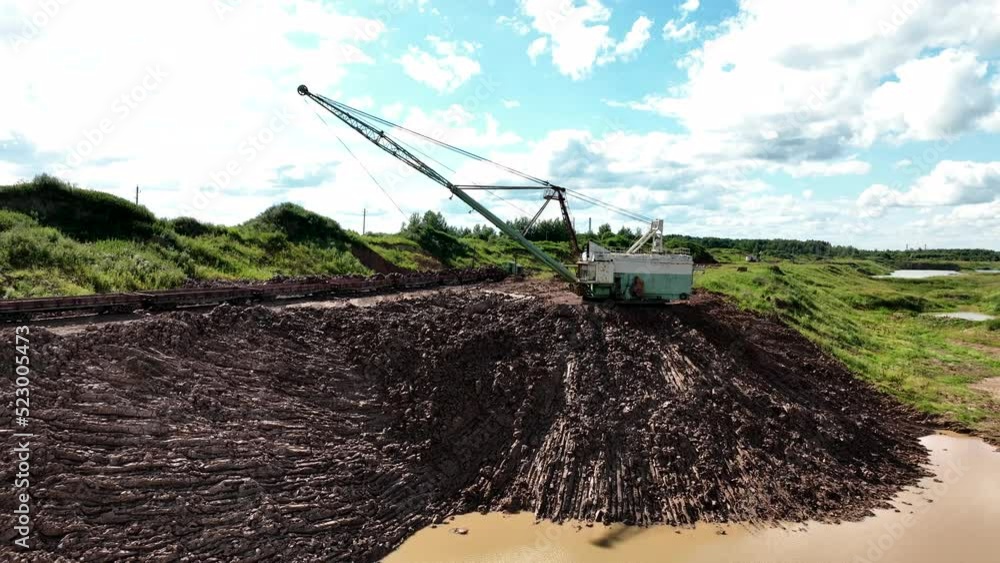Open-pit mining. Dragline excavator load clay in freight train. Clay ...