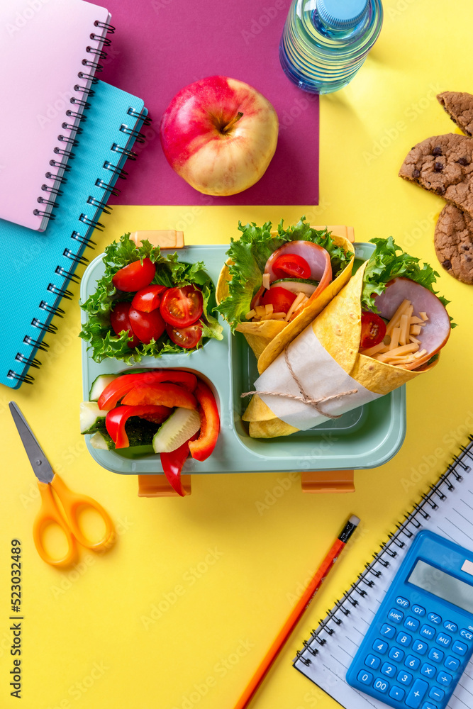 School lunch box for kids with sandwich, vegetables, water and ...