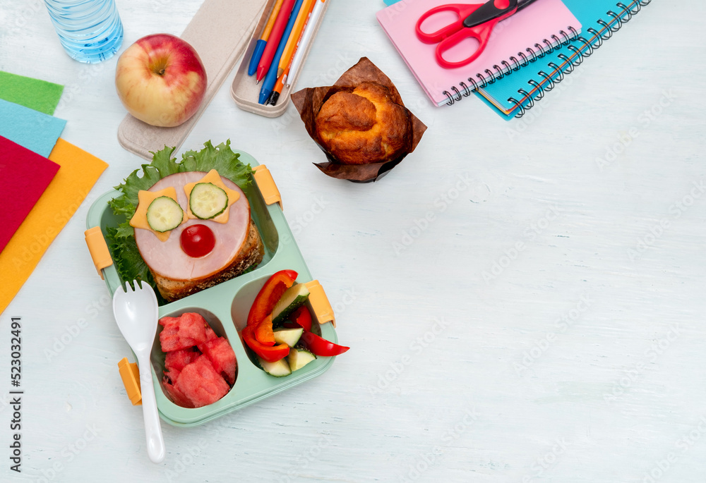 School lunch box for kids with food in the form of funny faces. School ...
