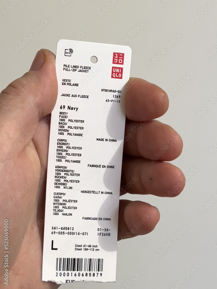 London, United Kingdom - Jan 3, 2022: POV male hand holding price tag ...