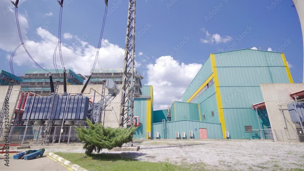 Nuclear power plant. Power transformers, cooling tower and buildings ...