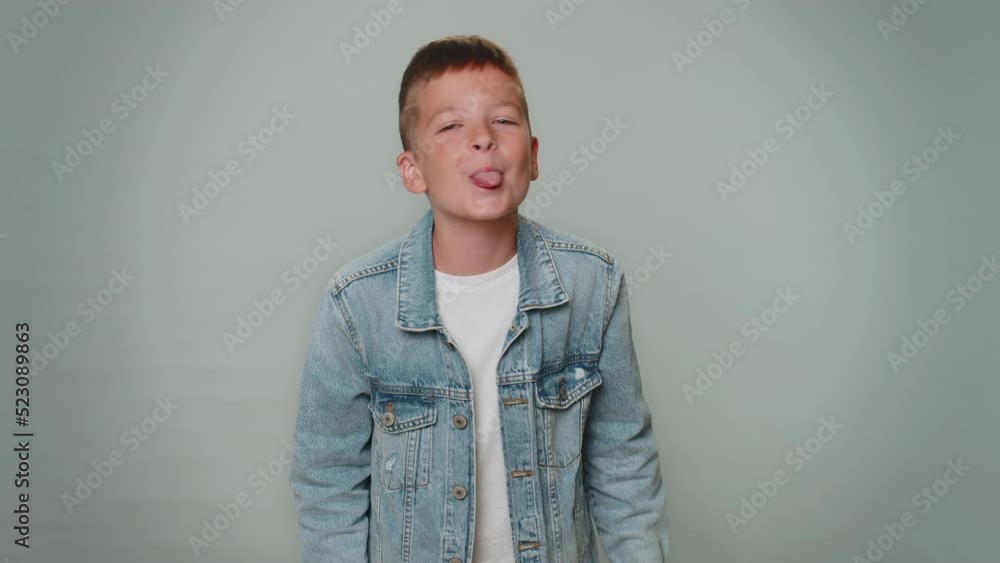 Cheerful funny bully toddler kid boy in jacket showing tongue making ...