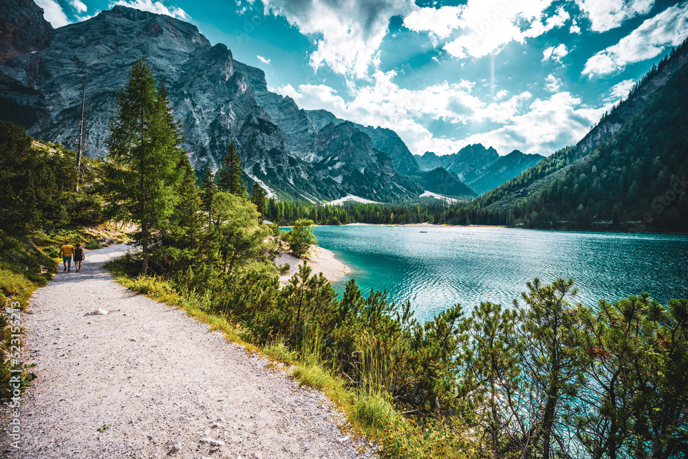 Beautiful view with boat on Baires Lake in the Dolomite mountains in the afternoon. Braies Lake ...