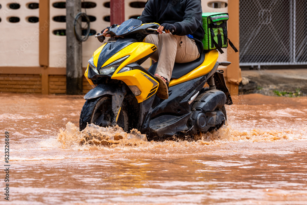 Riding a motorcycle through a flooded vehicle Stock Photo | Adobe Stock