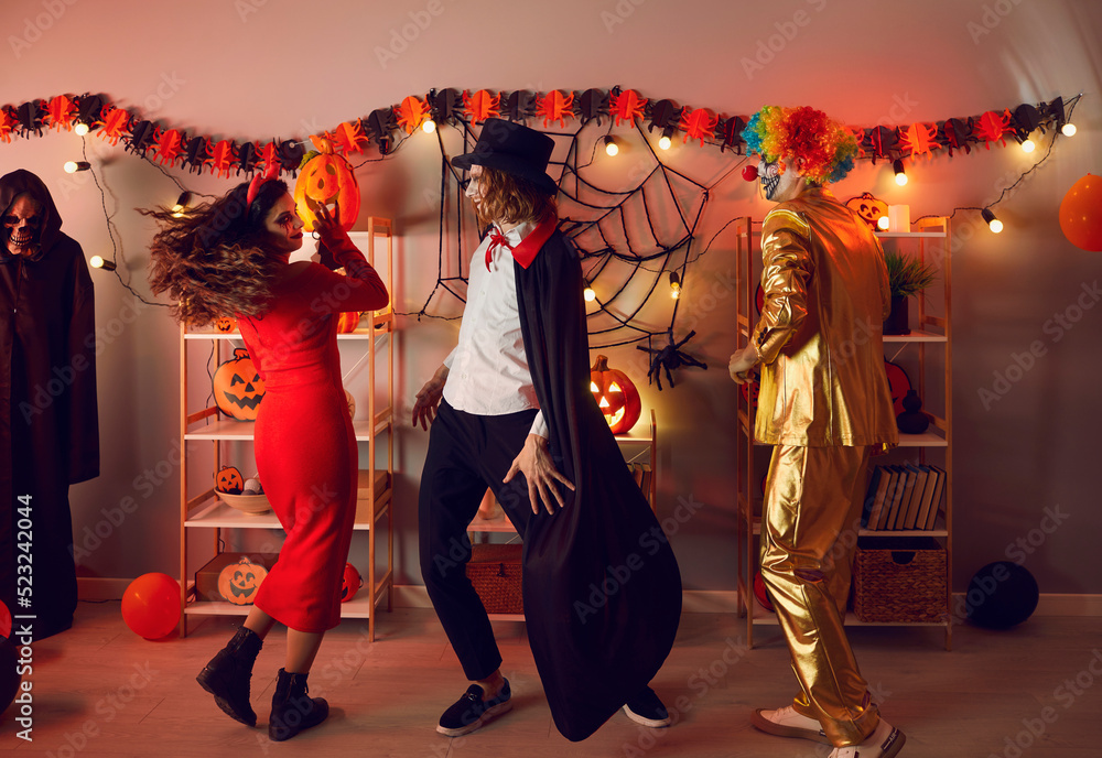 Happy diverse people in costumes makeup dance celebrate Halloween in ...