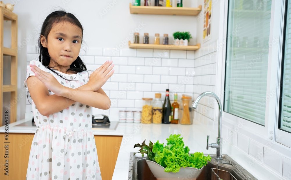 Asian Child girl looks with disgust for healthy food. child girl does ...