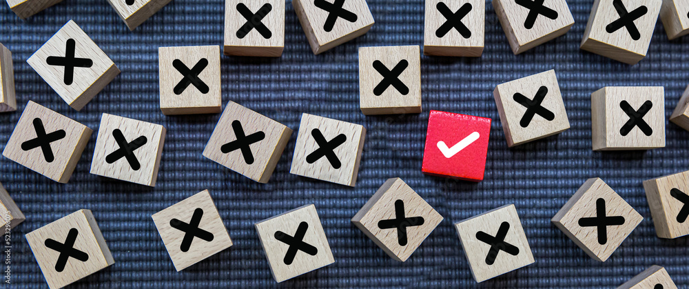 Check mark on cube wooden toy block with cross symbol for true or false ...