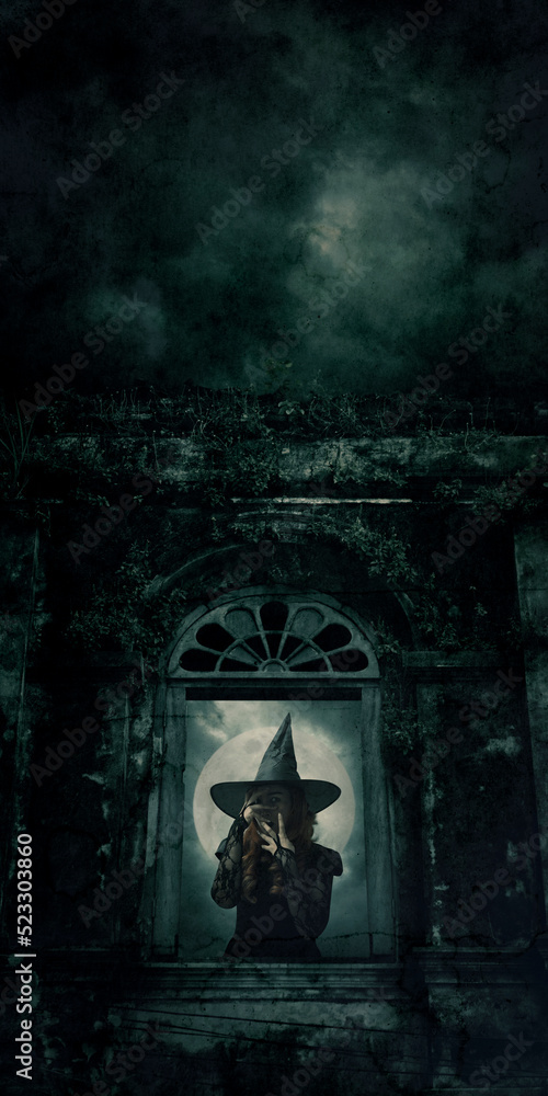 Scary halloween witch standing over ancient castle window wall, full ...