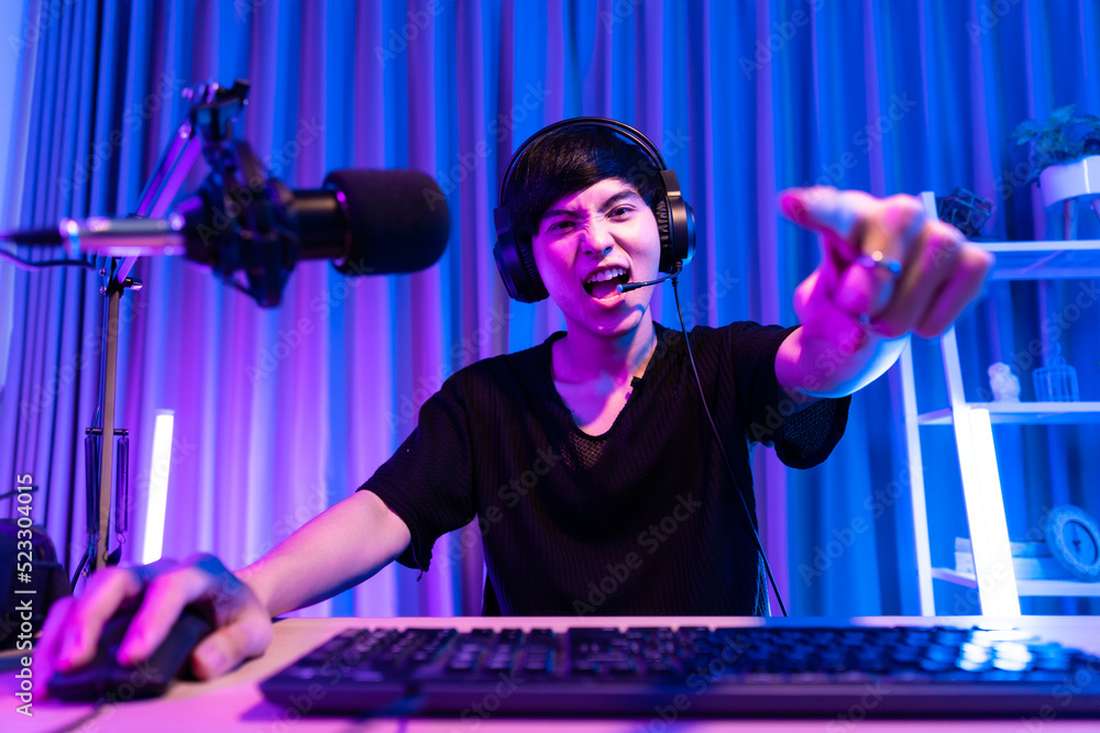 Playing video games on smartphone. Young asian handsome man sitting on ...