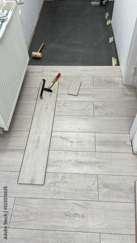 Work in progress, installation of laminate parquet, light oak type ...