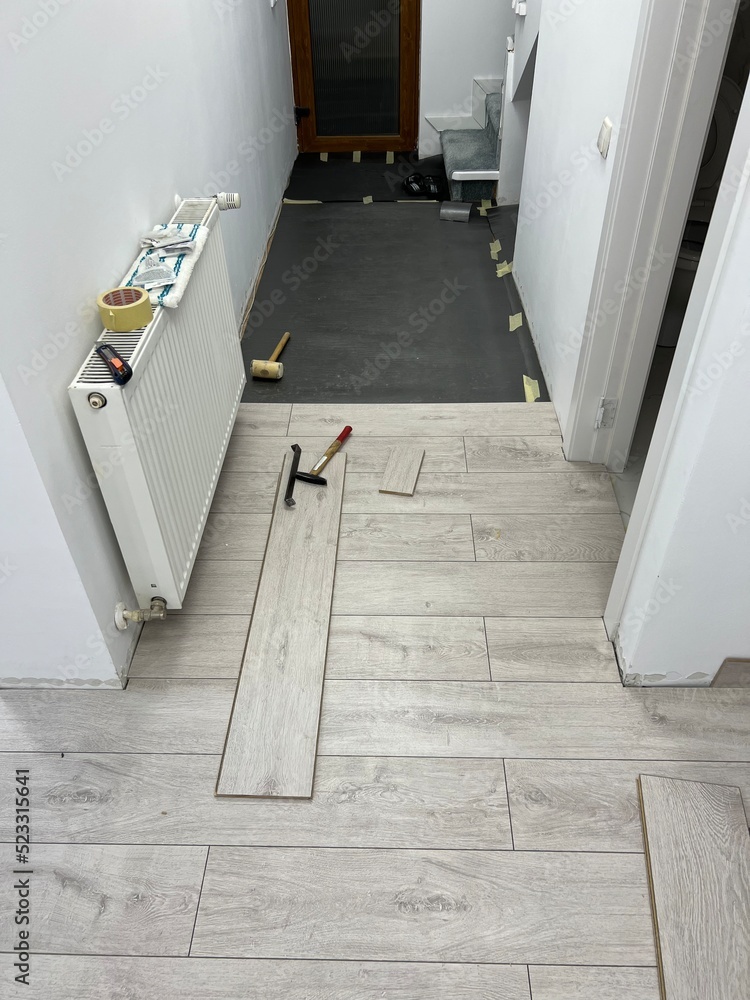 Work in progress, installation of laminate parquet, light oak type ...