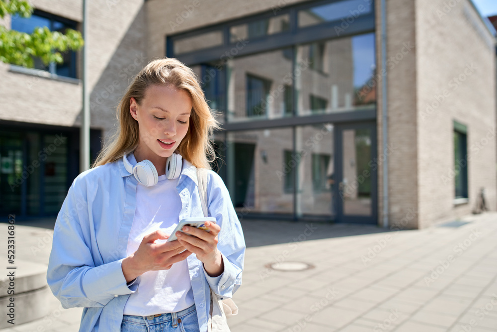 Beautiful cool girl university student holding cell phone using modern ...
