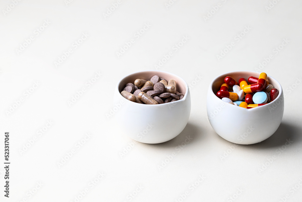 Medication pills, ear drops, eye drops and nose spray against blue ...