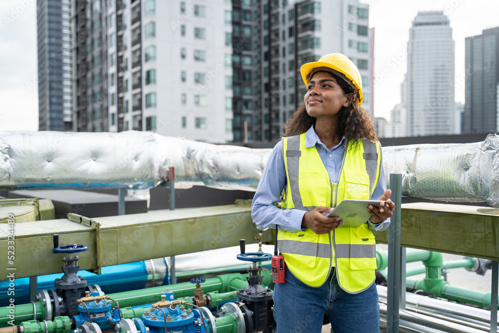 Service engineer woman dark skin wearing uniform and safety helmet ...