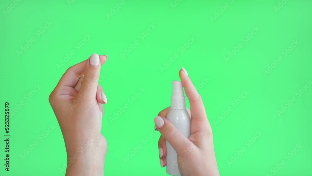 Human hands spraying sanitizer gel on a Chroma Key. Girl hands treats ...