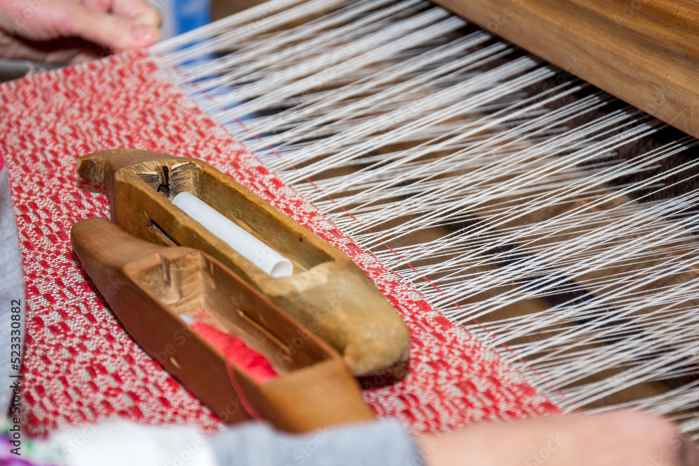 Old craft. Elements of ancient weaving loom in an interior of a wooden ...