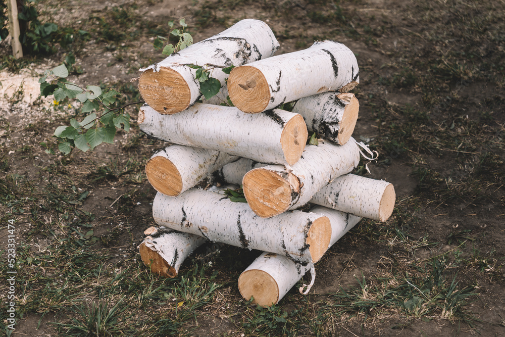 Thick birch logs close-up. Wood harvesting at the sawmill. A pile of ...
