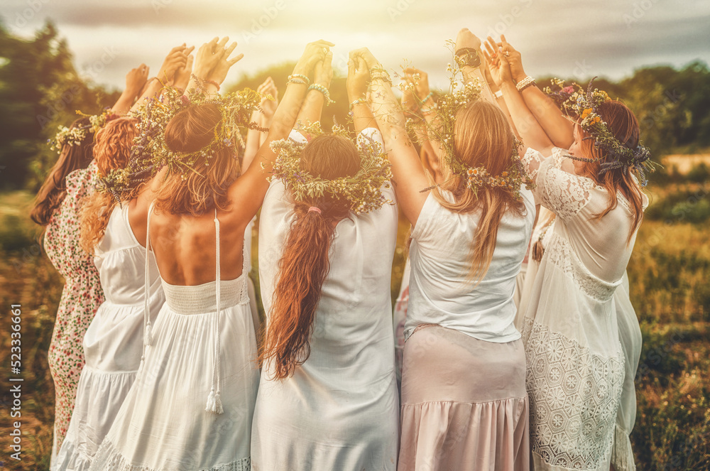 Women in flower wreath on sunny meadow, Floral crown, symbol of summer ...