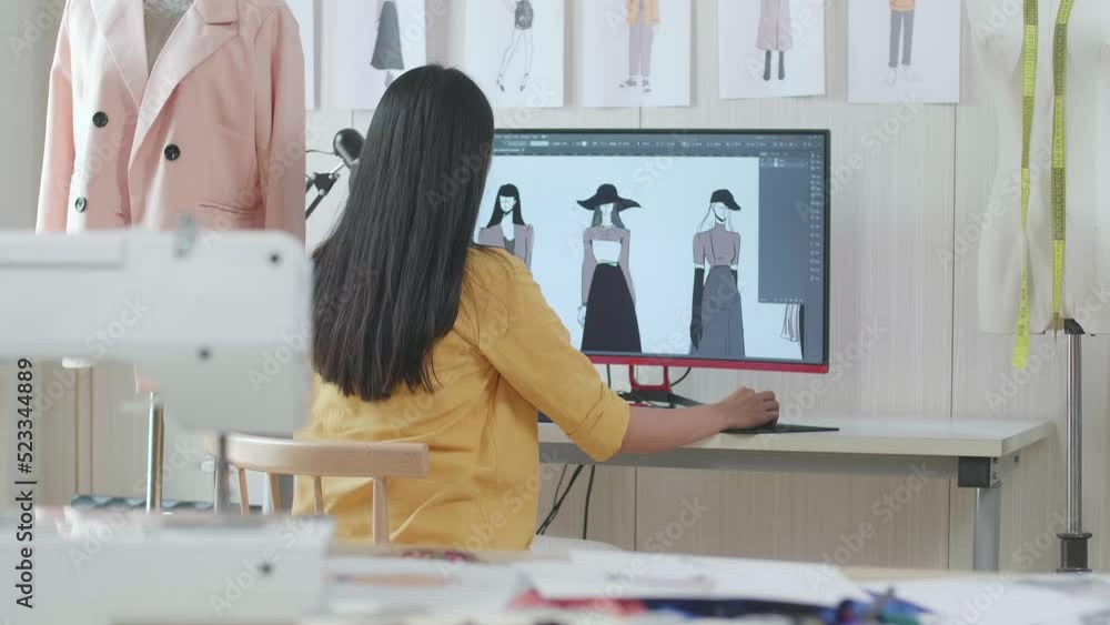 Back View Of A Female Designer Designing Clothes On A Desktop In The ...
