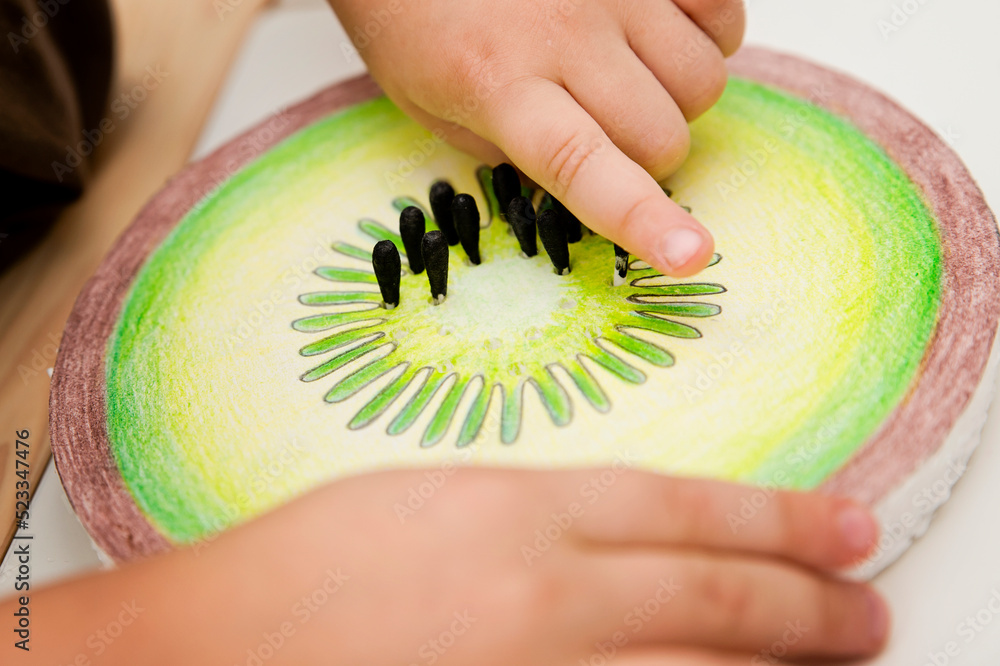 Slice of Kiwi fruit. DIY home made paper toy. Seeds made of black ...