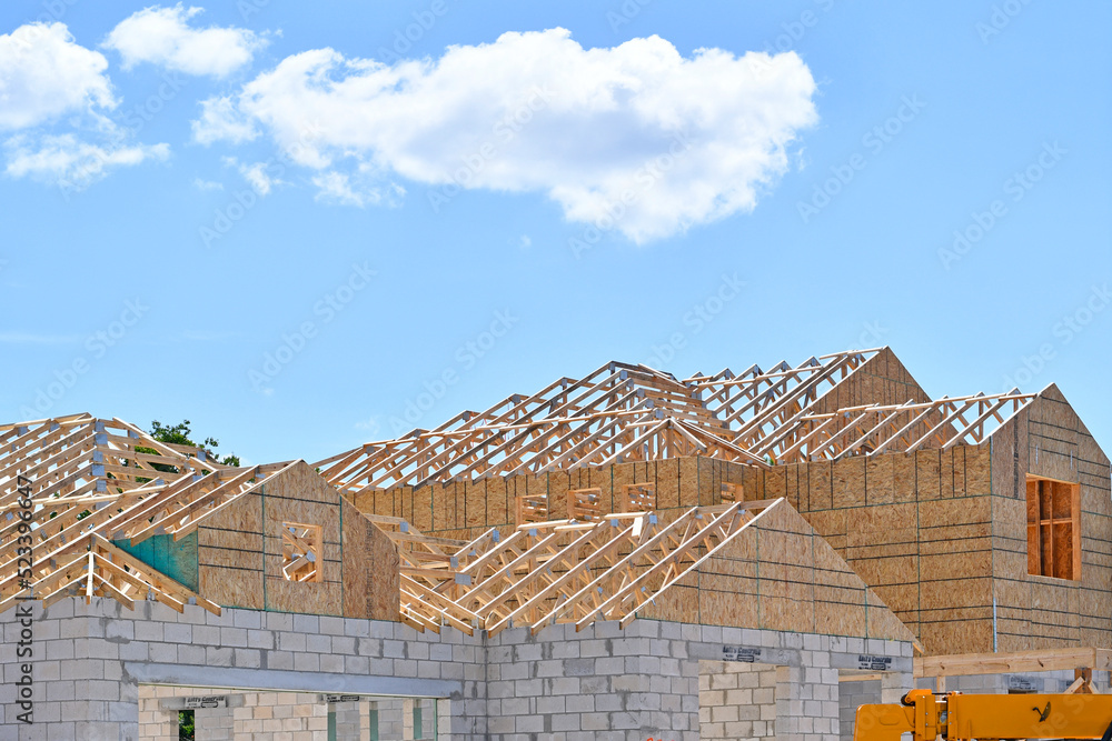 Incomplete residential homes under construction at with wood frame ...