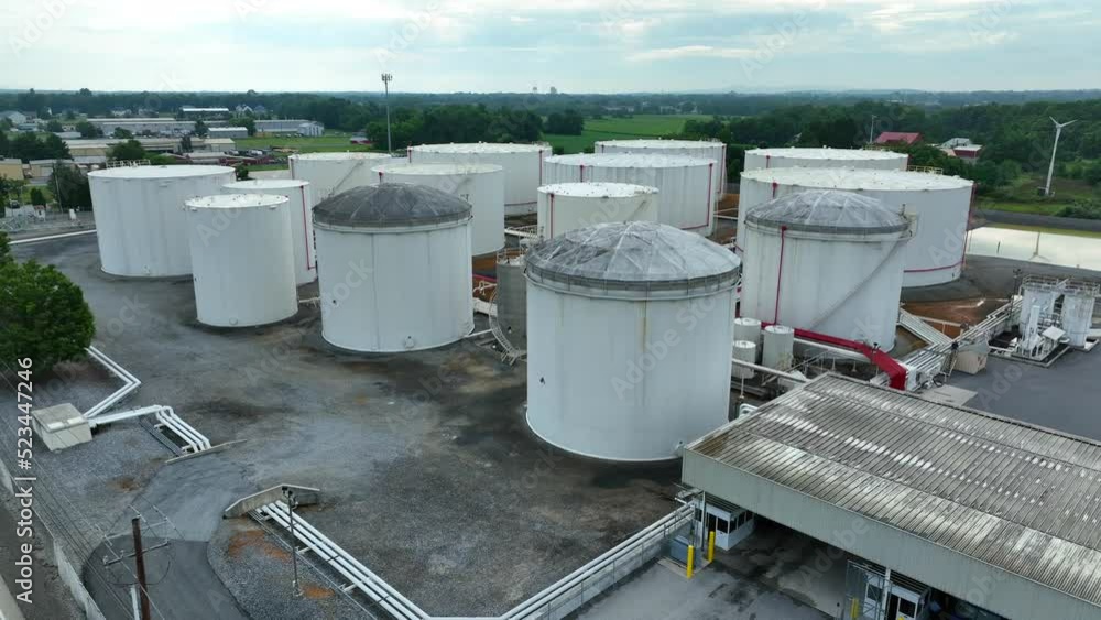 Fuel trucks at oil gas terminal with bulk storage tanks. Energy ...