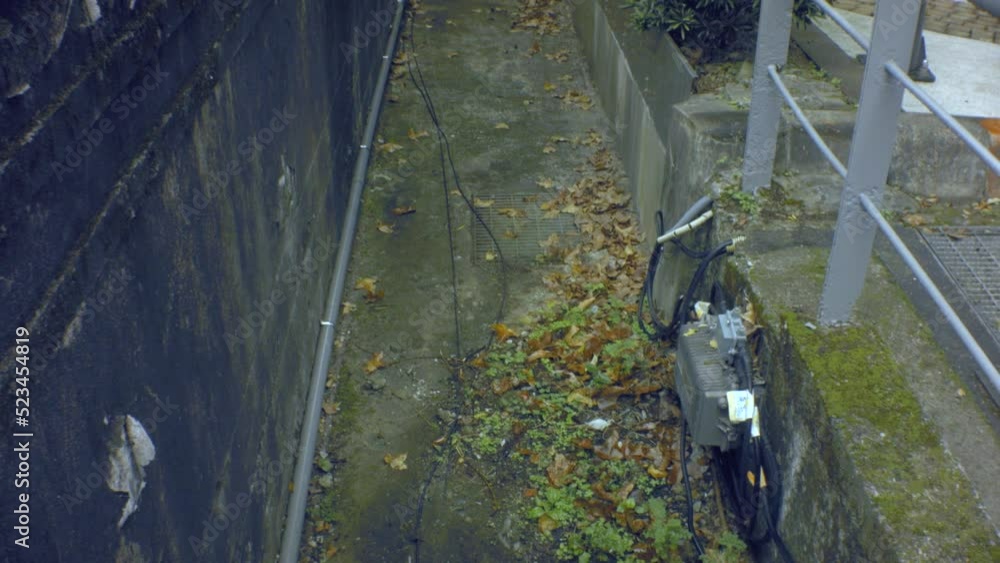 vertical down to up view to a dry trench ditch made of concrete cement ...