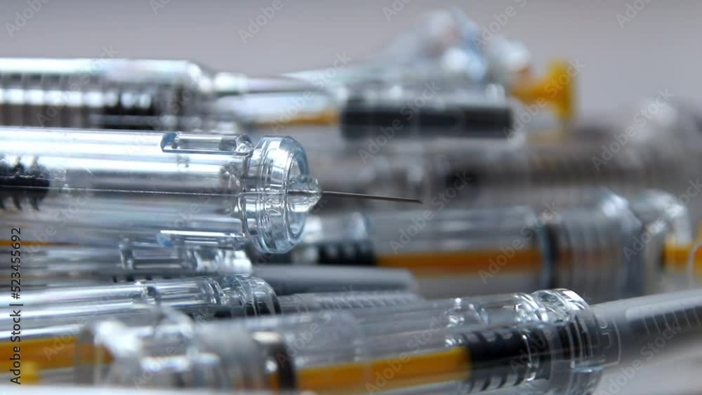 Bunch of injection syringes as vaccinations doses and booster ...