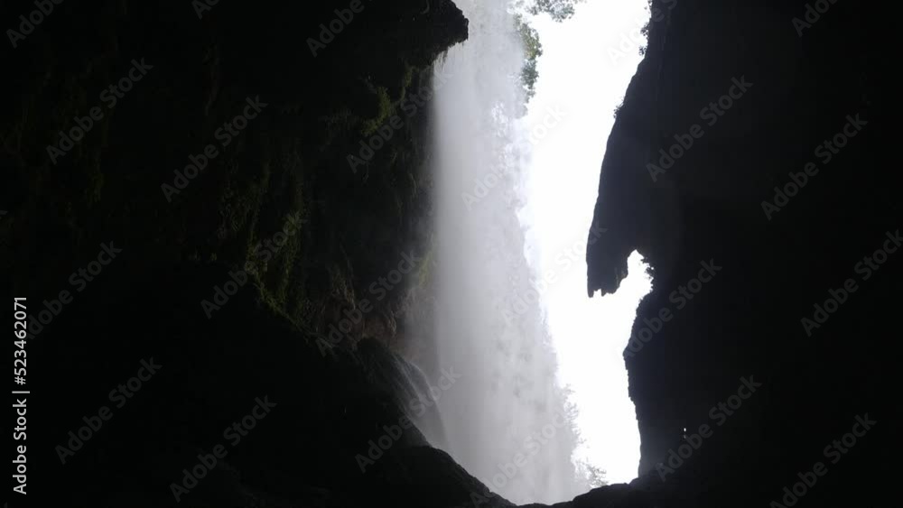 Video Stock Inside a cave behind a huge waterfall. Water plunge in ...