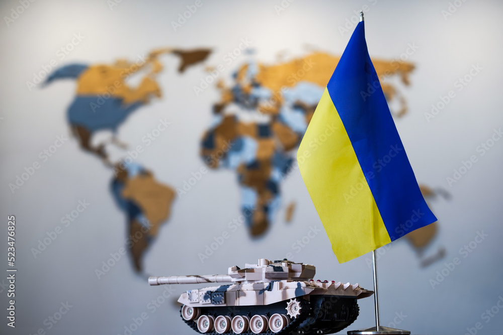 Tank with the Ukrainian flag on the background of the world map ...