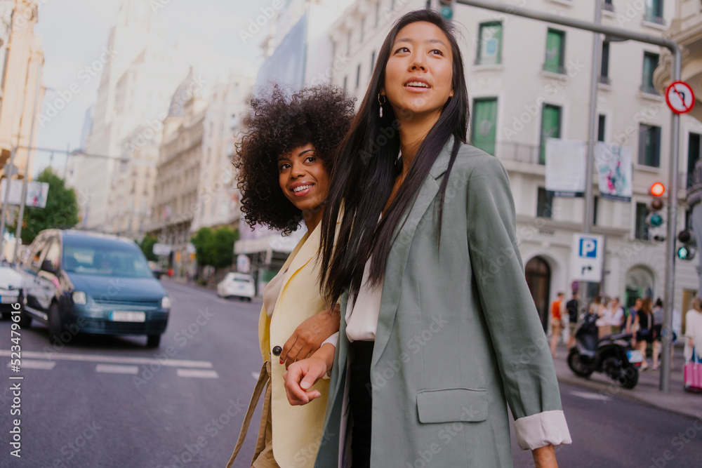 Multiracial friends crossing road together in city Stock Photo | Adobe ...