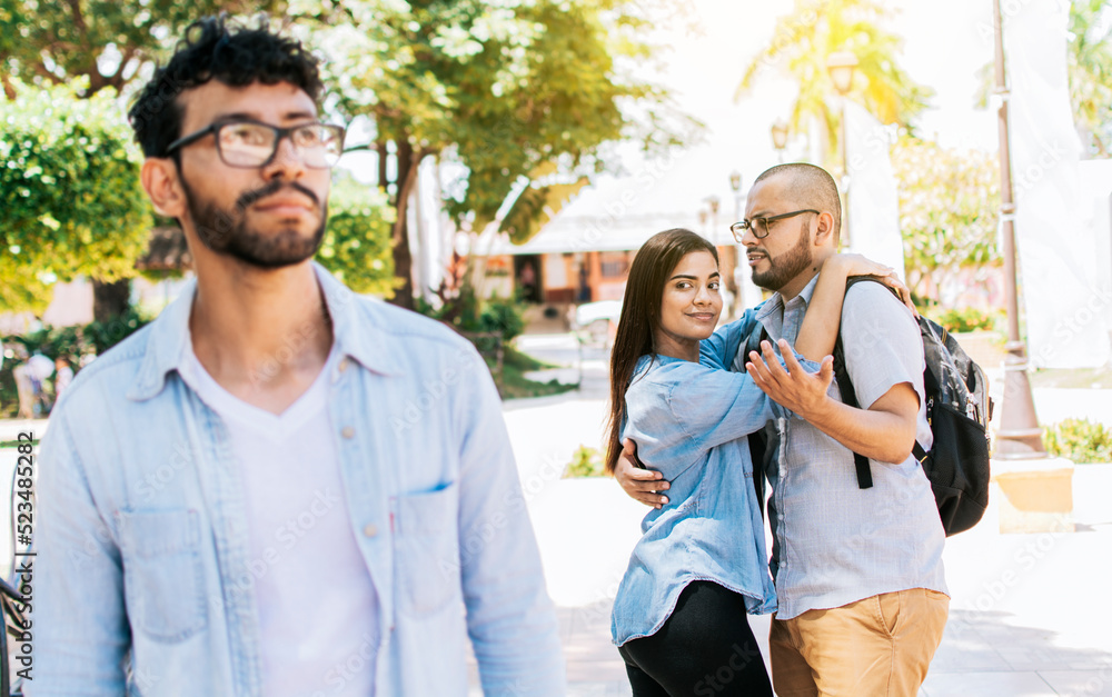 Distracted girlfriend looking at another man on the street. Unfaithful ...