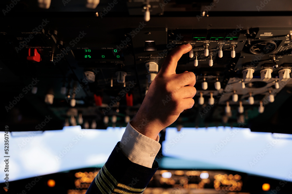 Hand of captain pushing dashboard buttons on control panel command to ...