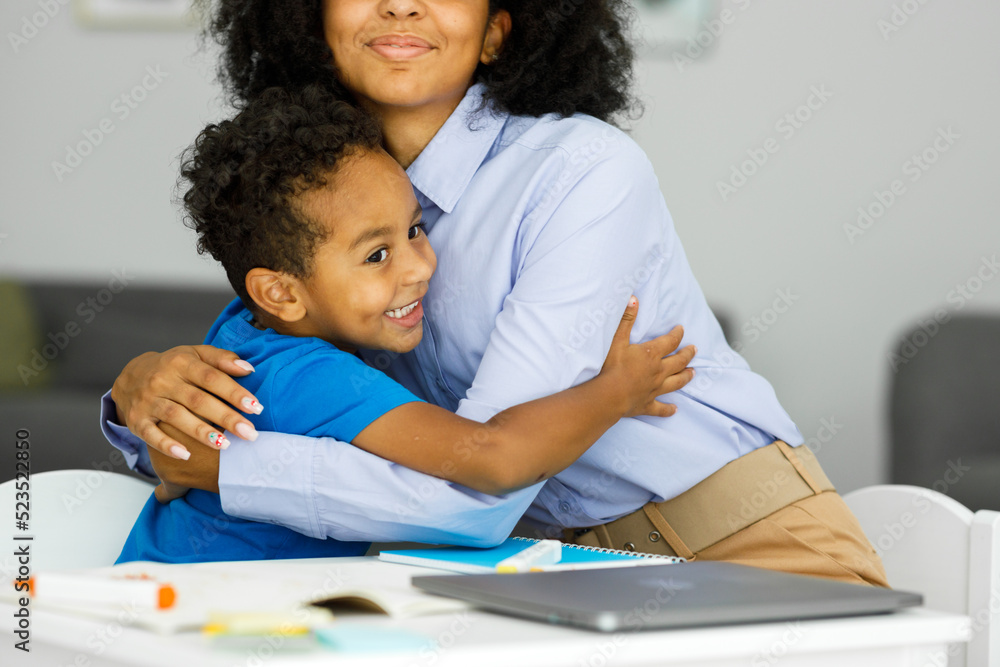 Happy african son hugging his mother on mother's day during the ...