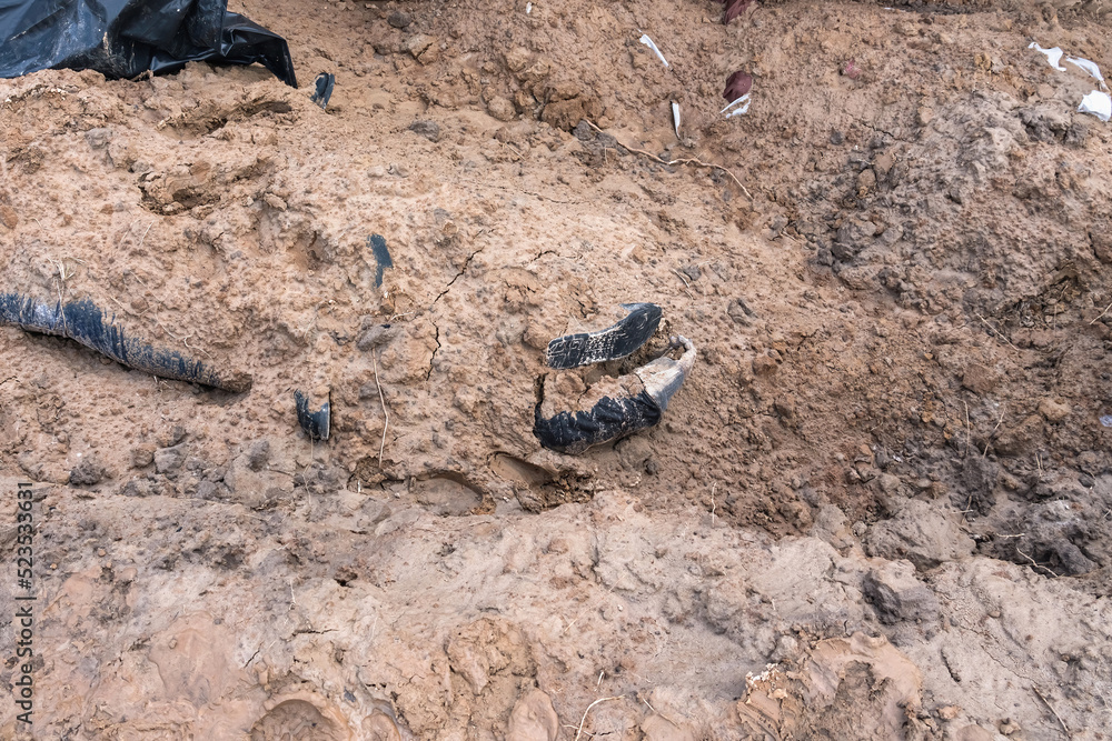 Fragments of bodies. Mass grave of civilians shot by the troops of the ...