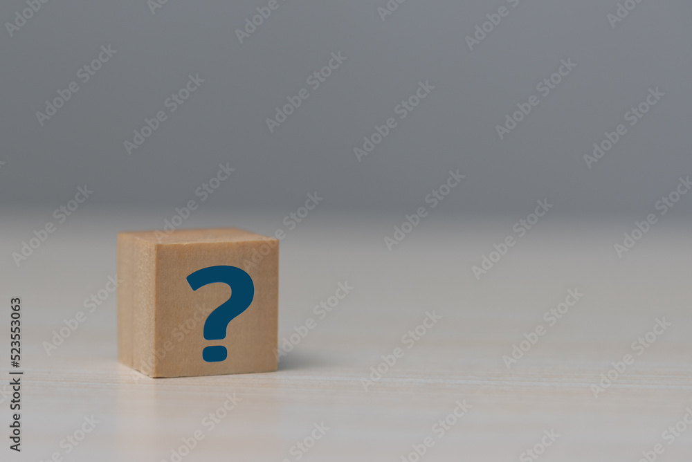 Wooden cube block shape with sign question mark symbol on table. Stock ...