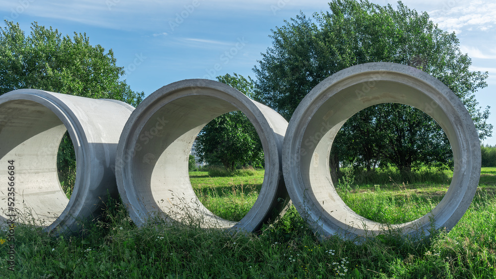 Reinforced concrete storm sewer pipes of large diameter stacked at a ...