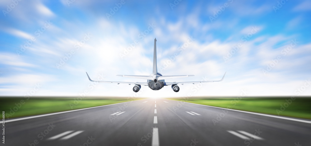 Airplane taking off from Airport runway at beautiful blue sky ...