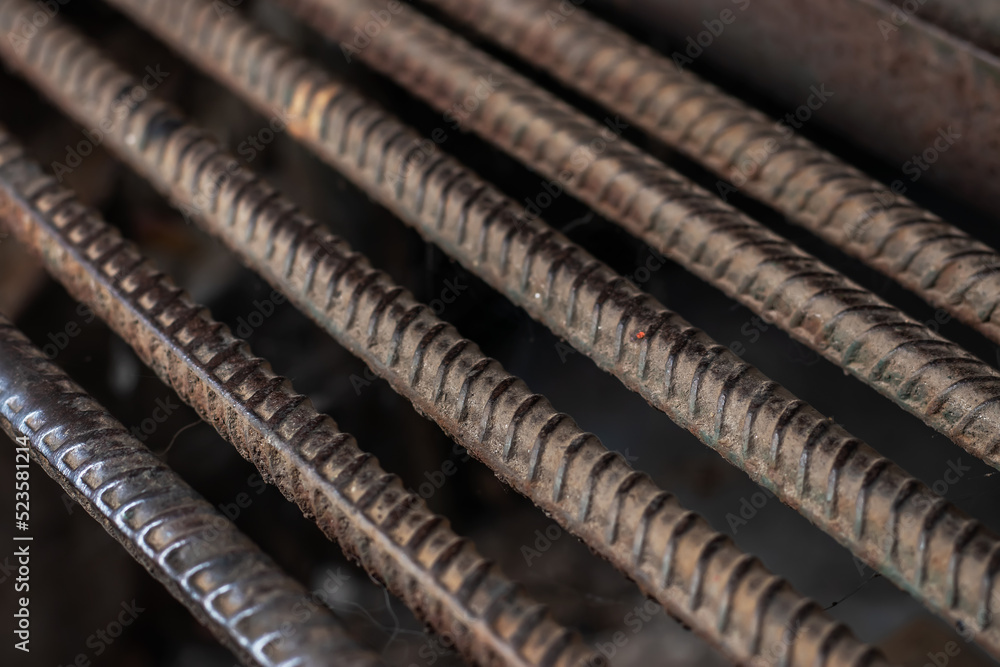Stack of heavy metal reinforcement bars with periodic profile texture ...