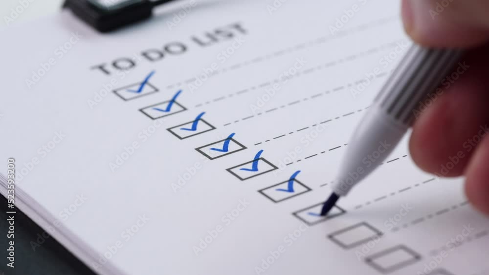 Checklist and To Do List Concept. After finishing a job on white paper ...