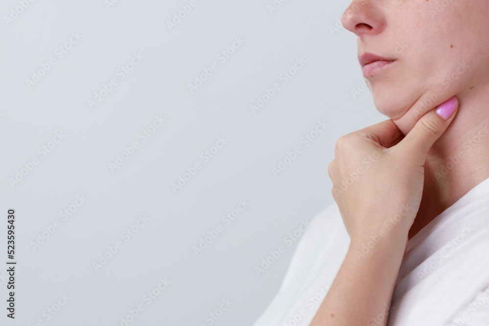 Closeup of woman's secong chin, problems with excess weight. Woman is ...