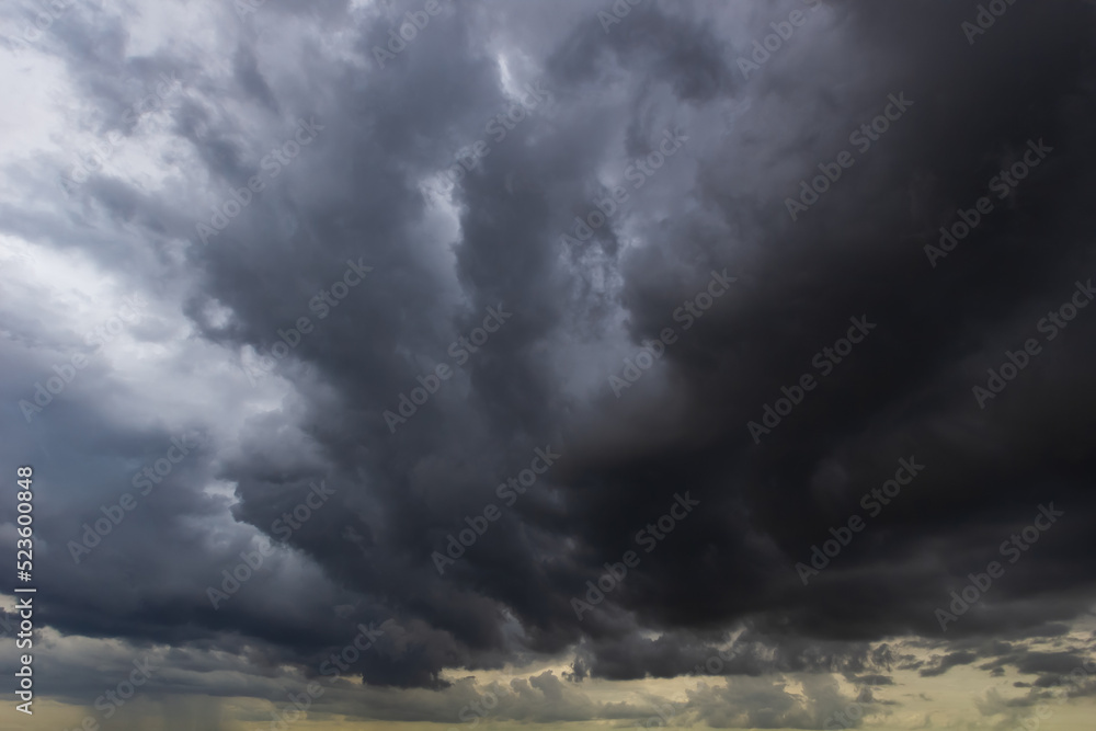 The dark sky with heavy clouds converging and a violent storm before ...