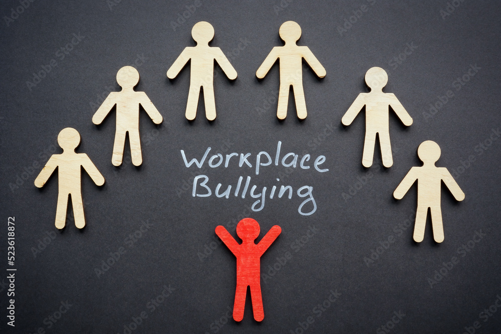 Workplace bullying and wooden figurines on the dark surface. Stock ...