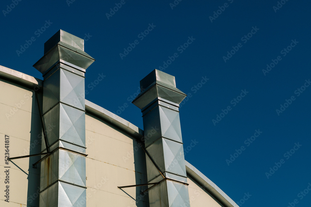 Foto de ventilation system building: chimney of an industrial building ...