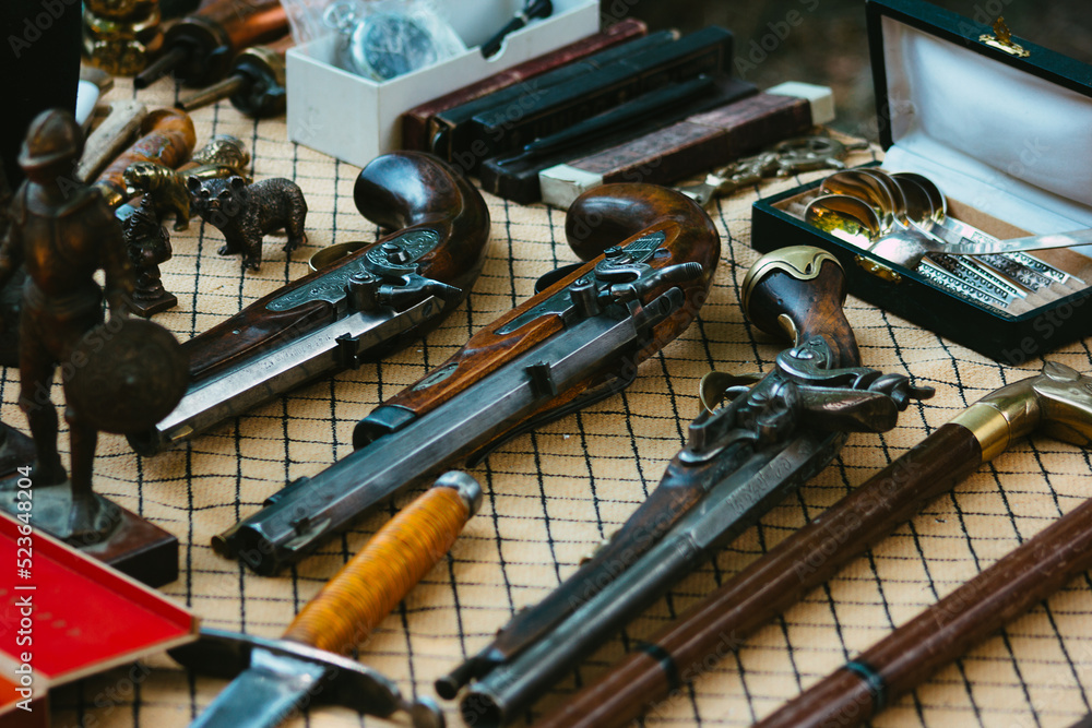 Collection of antique weapons at the flea market. Sale of antiques at a ...