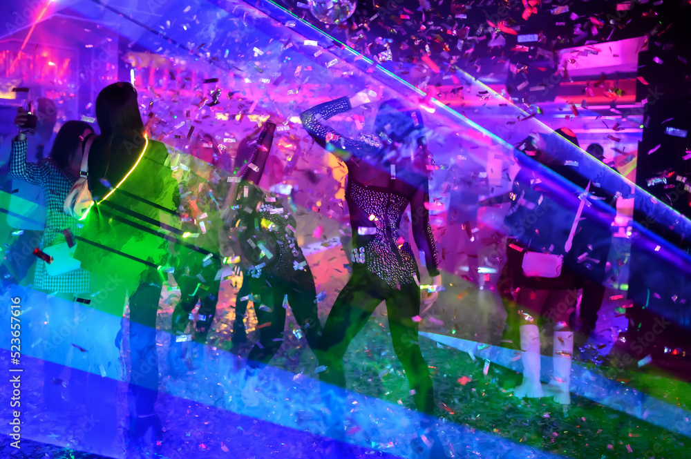 Laser show rays stream. Very colorful show with a crowd silhouette and ...